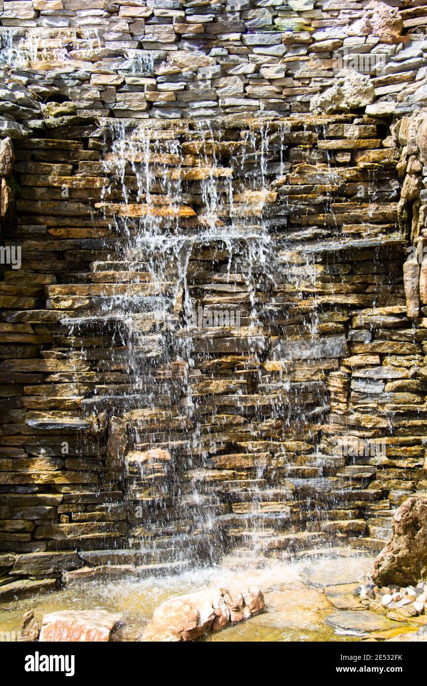Small rocky waterfall pouring into a small pool Stock Photo - Alamy