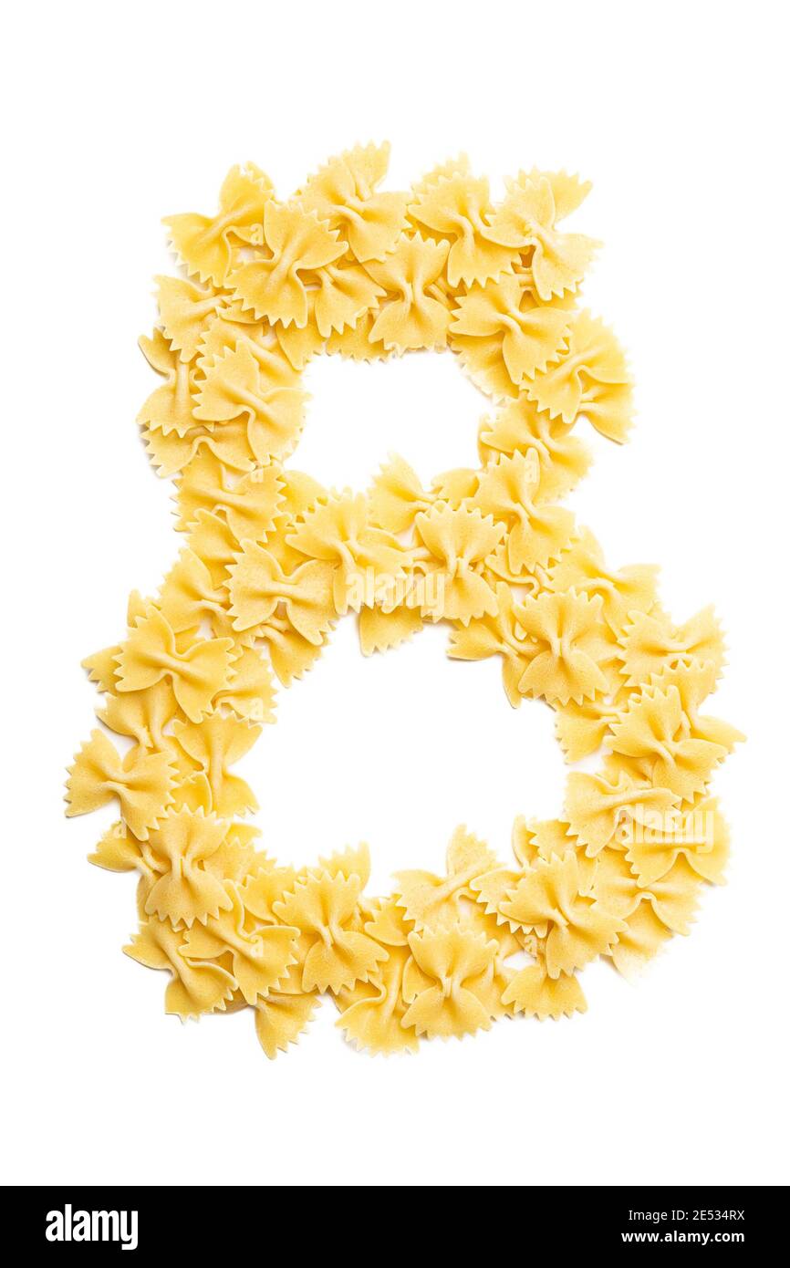 Arabic numeral "8" from dry farfalle pasta on a white isolated ...