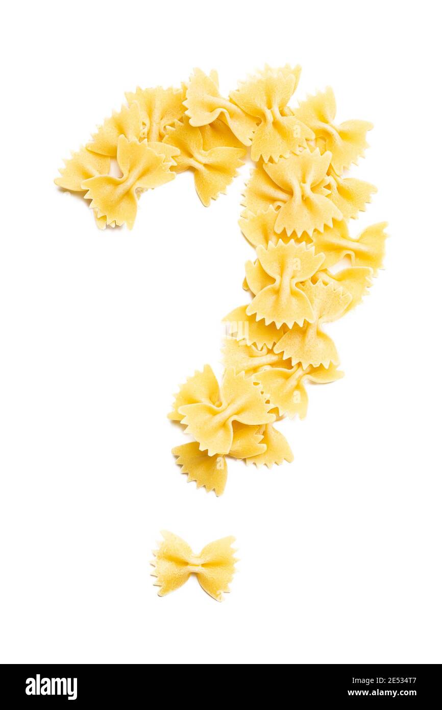question mark from dry farfalle pasta on a white isolated background ...