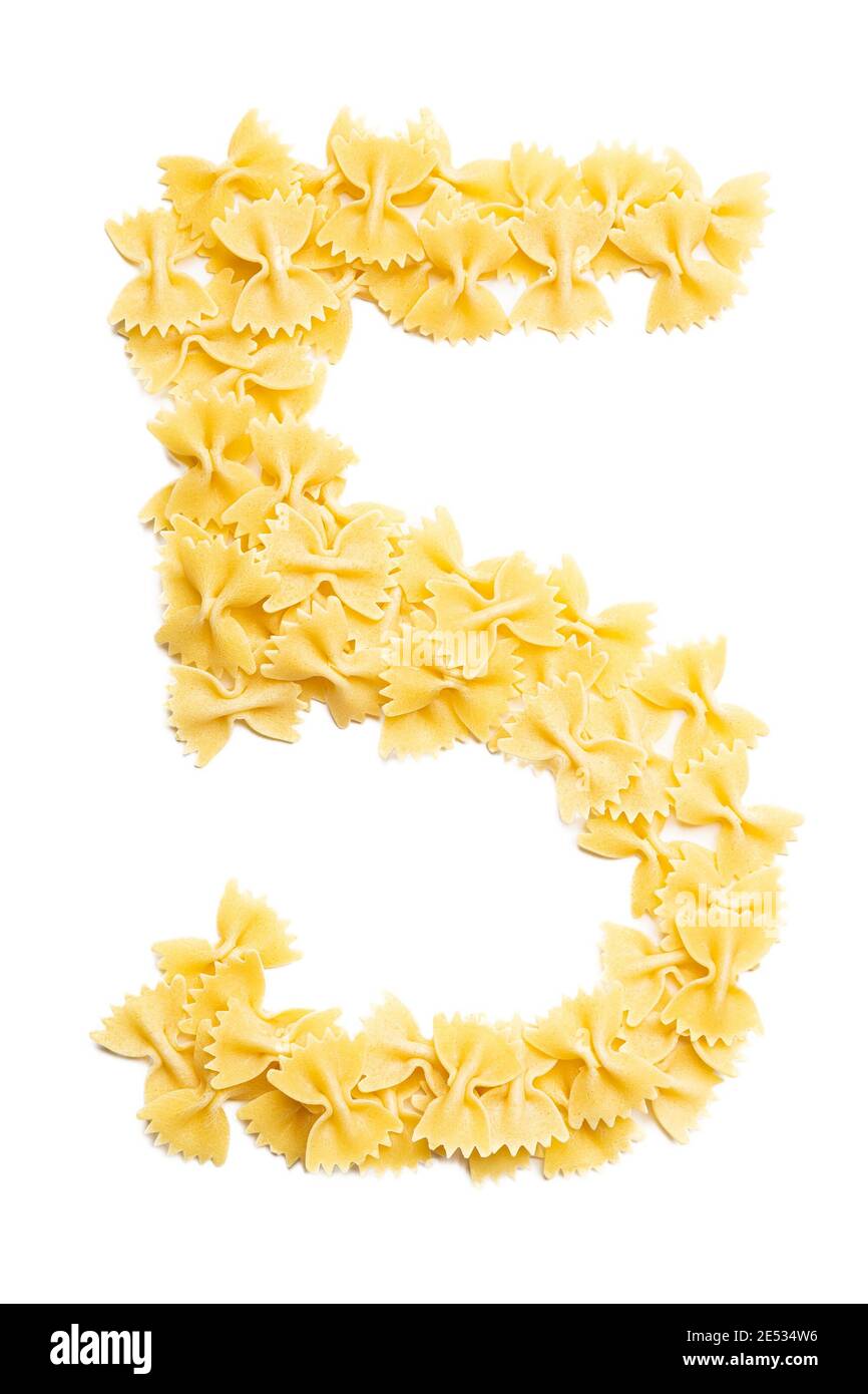 Arabic numeral "5" from dry farfalle pasta on a white isolated ...