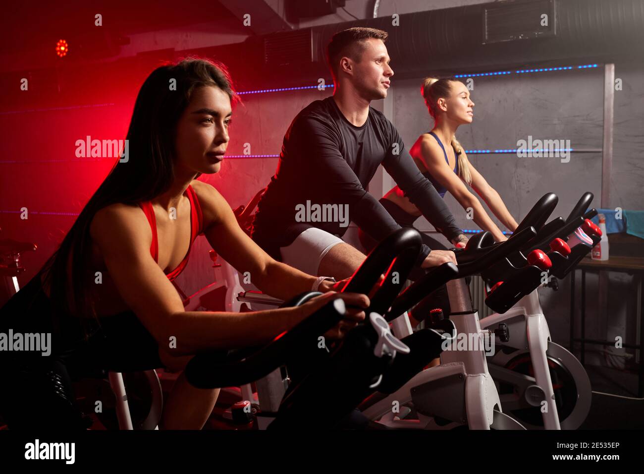 people exercising, legs cardio training on bicycle in fitness gym, for ...