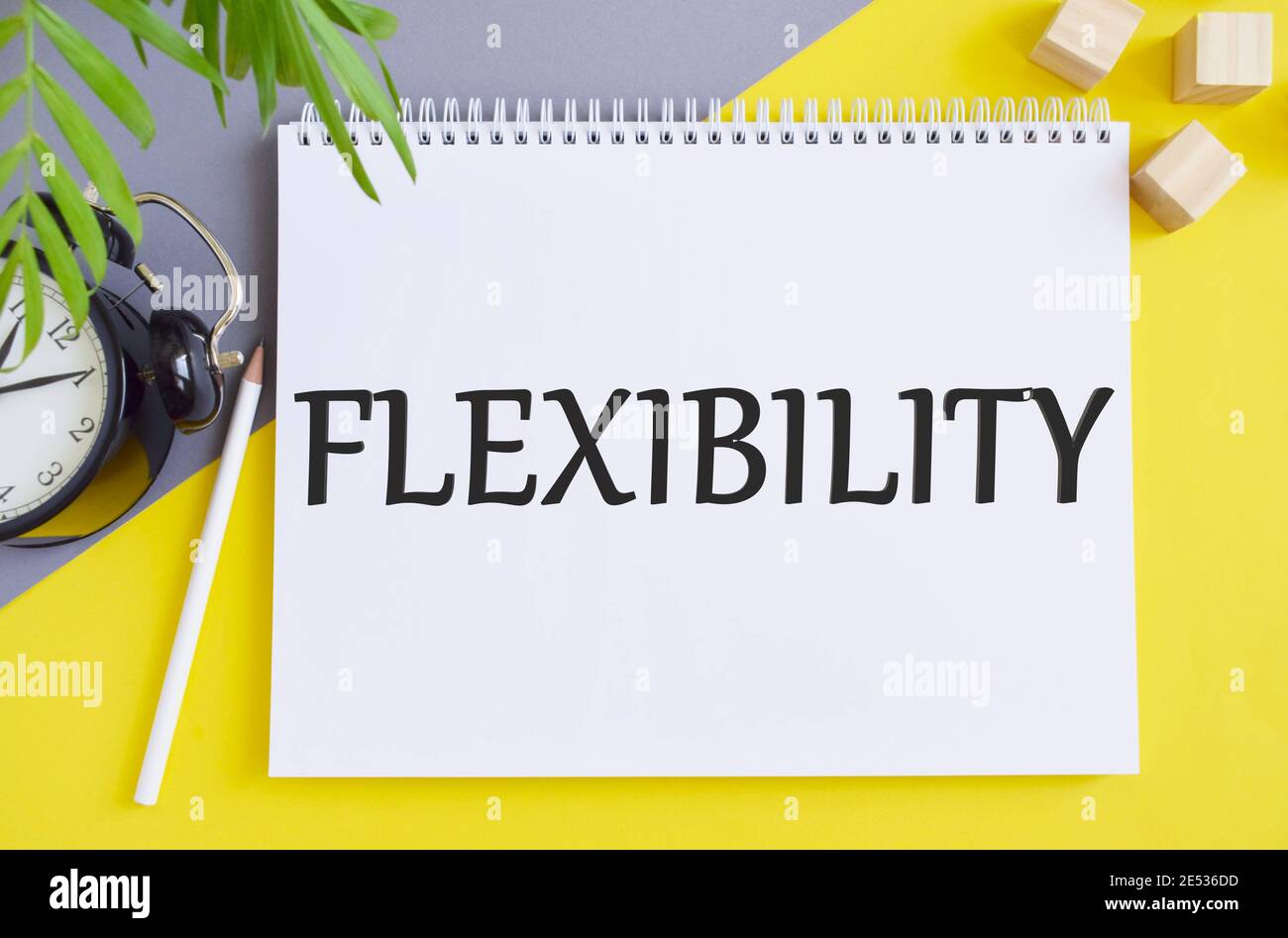 The text Flexibility written on white notebook on office table ...