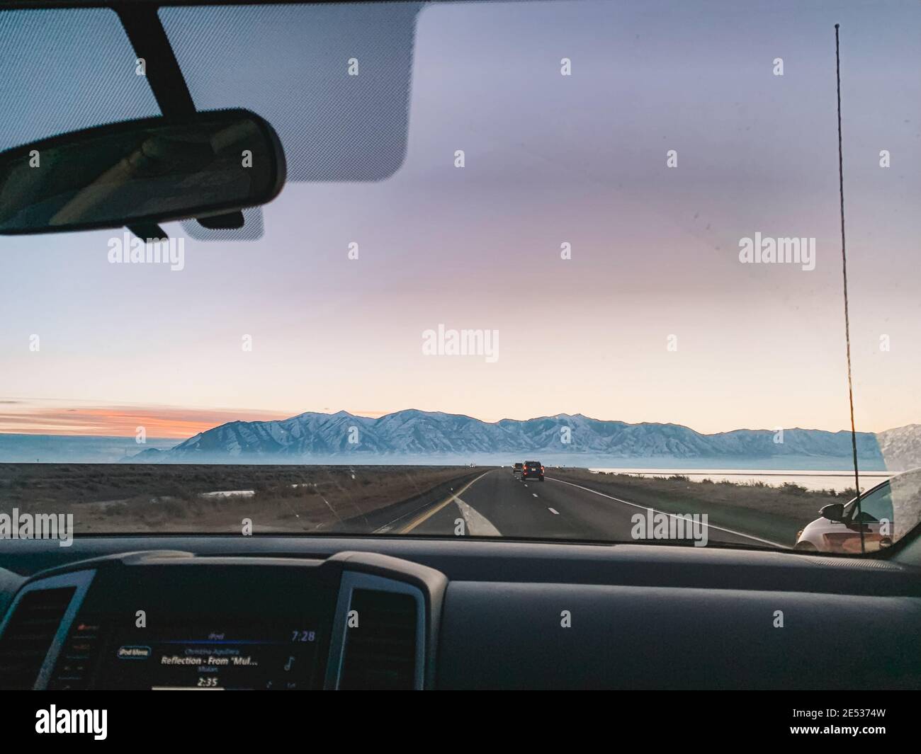Interior of a car being driven on a countryside road during sunset ...