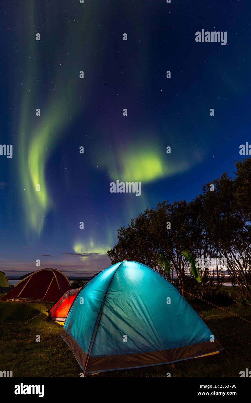 Wide angle night view of a camping resort with a blue and red sleeping ...