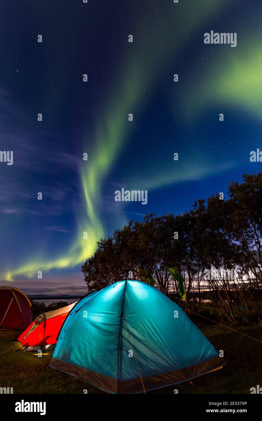 Wide angle night view of a camping resort with a blue and red sleeping ...