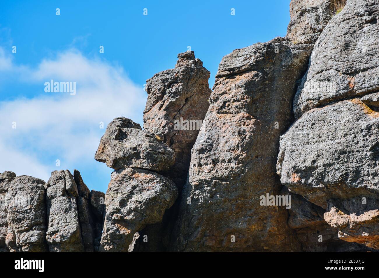 Stone hills and mountains against a blue sky with white clouds Stock ...