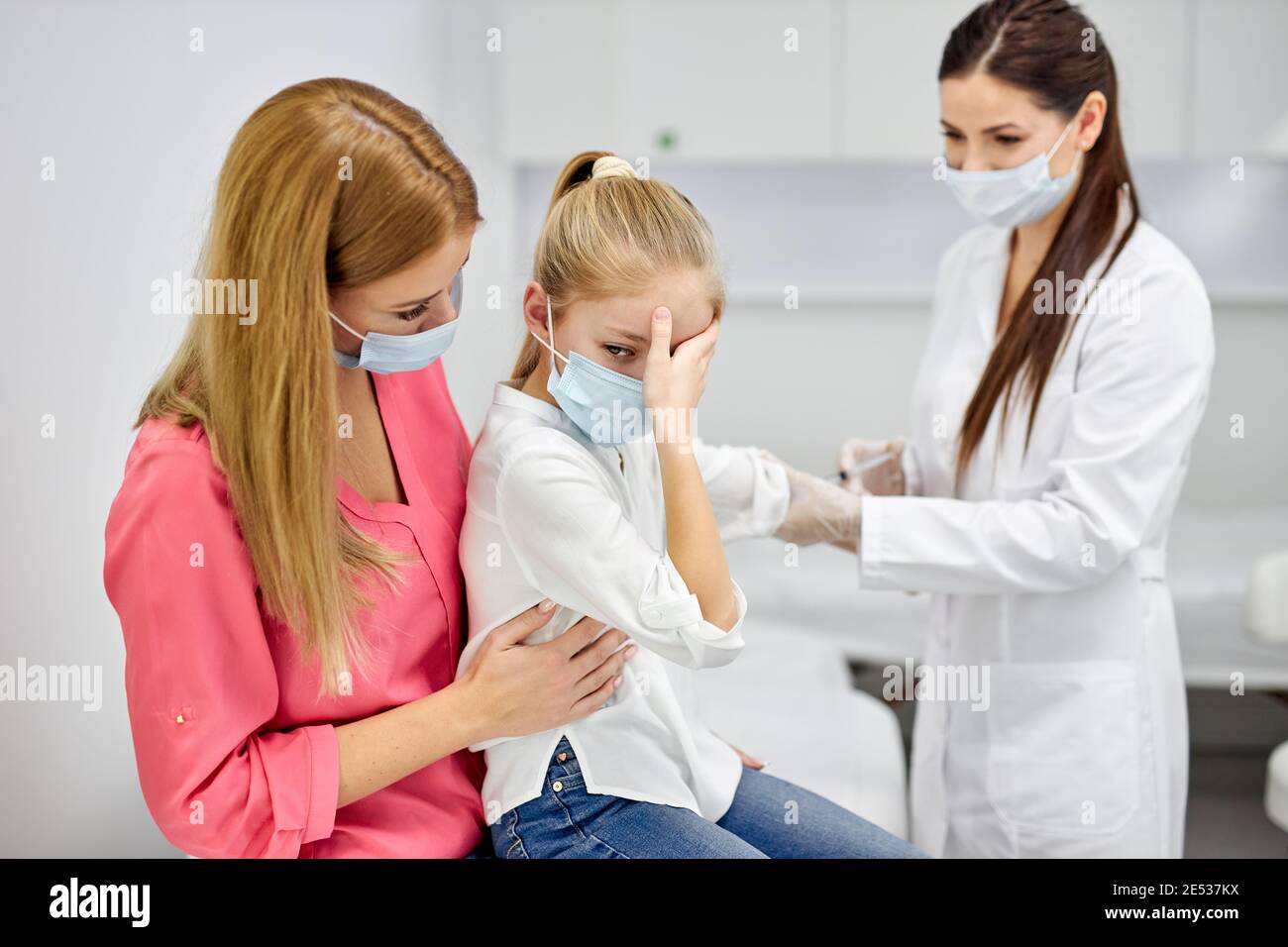 female doctor taking blood sample test of a little girl in the clinic ...