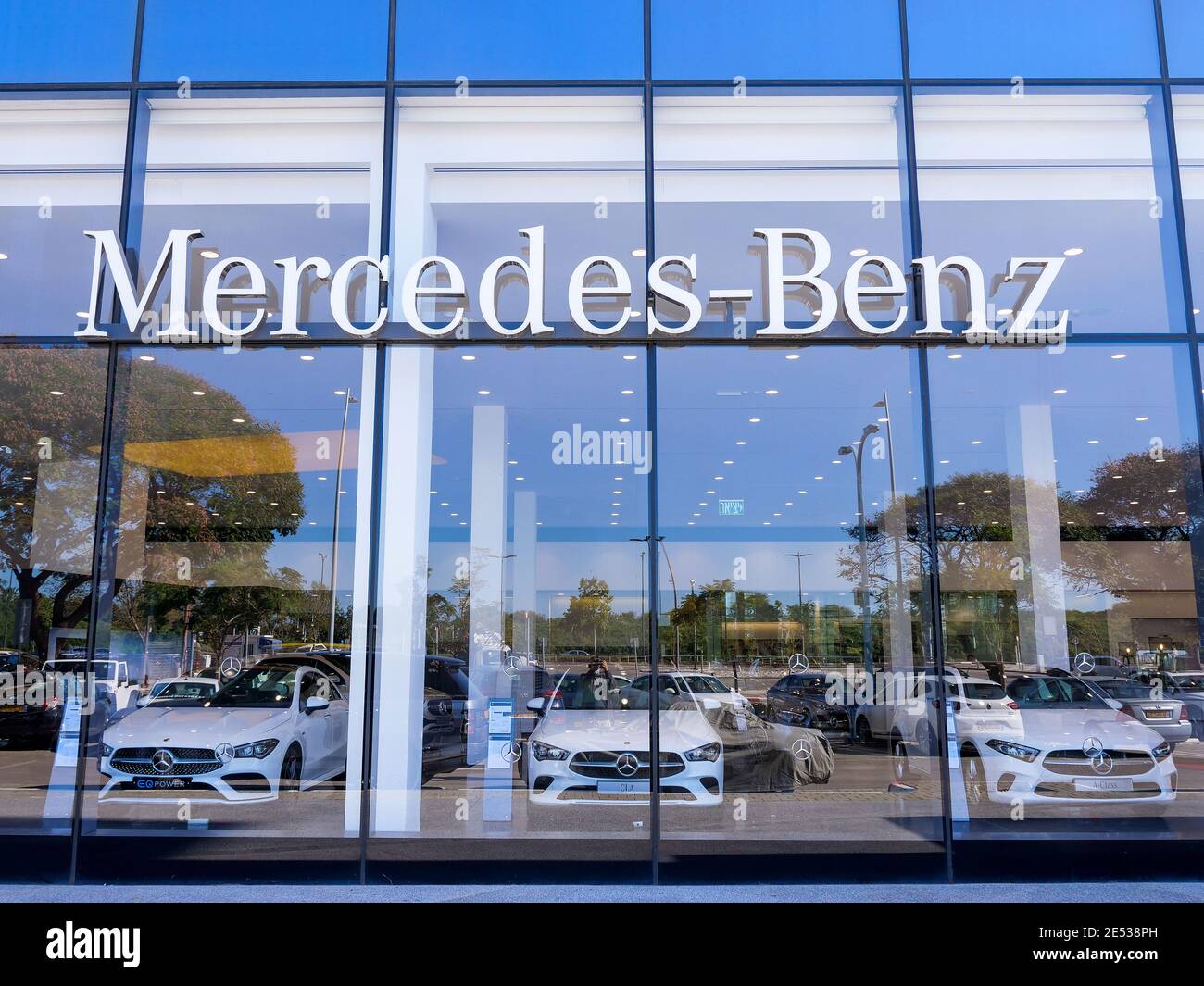 Mercedes Benz sign on a local dealership building windows Stock Photo ...