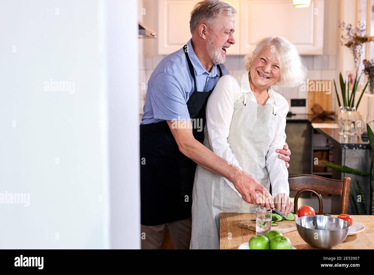 Elderly couple carving vegetables hi-res stock photography and images ...