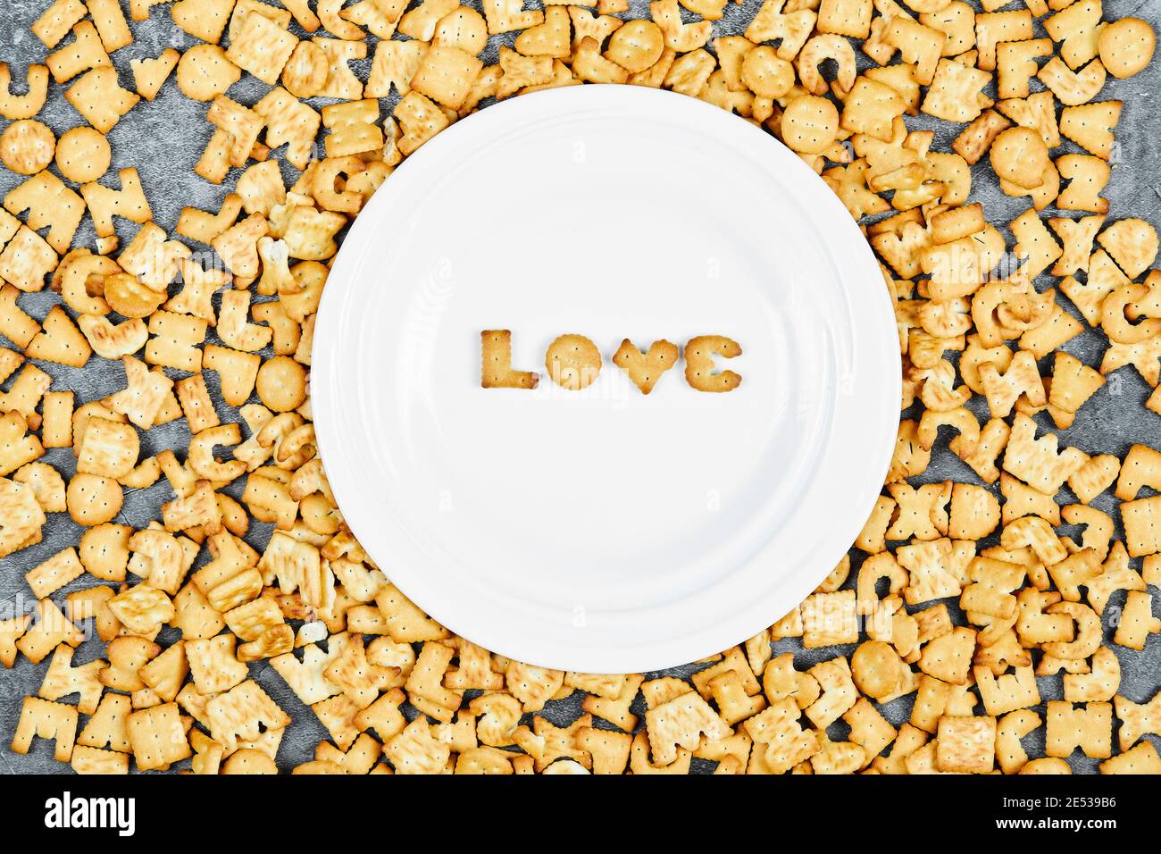 Letter shape crackers on the ground and in a white saucer Stock Photo ...