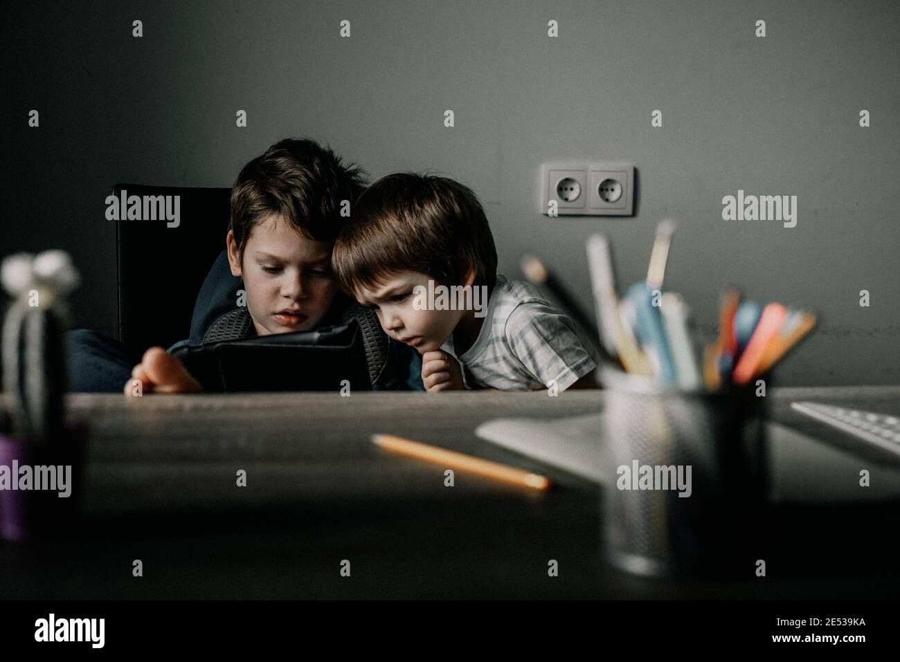 Children playing tablet at home, growing up with technology Stock Photo ...