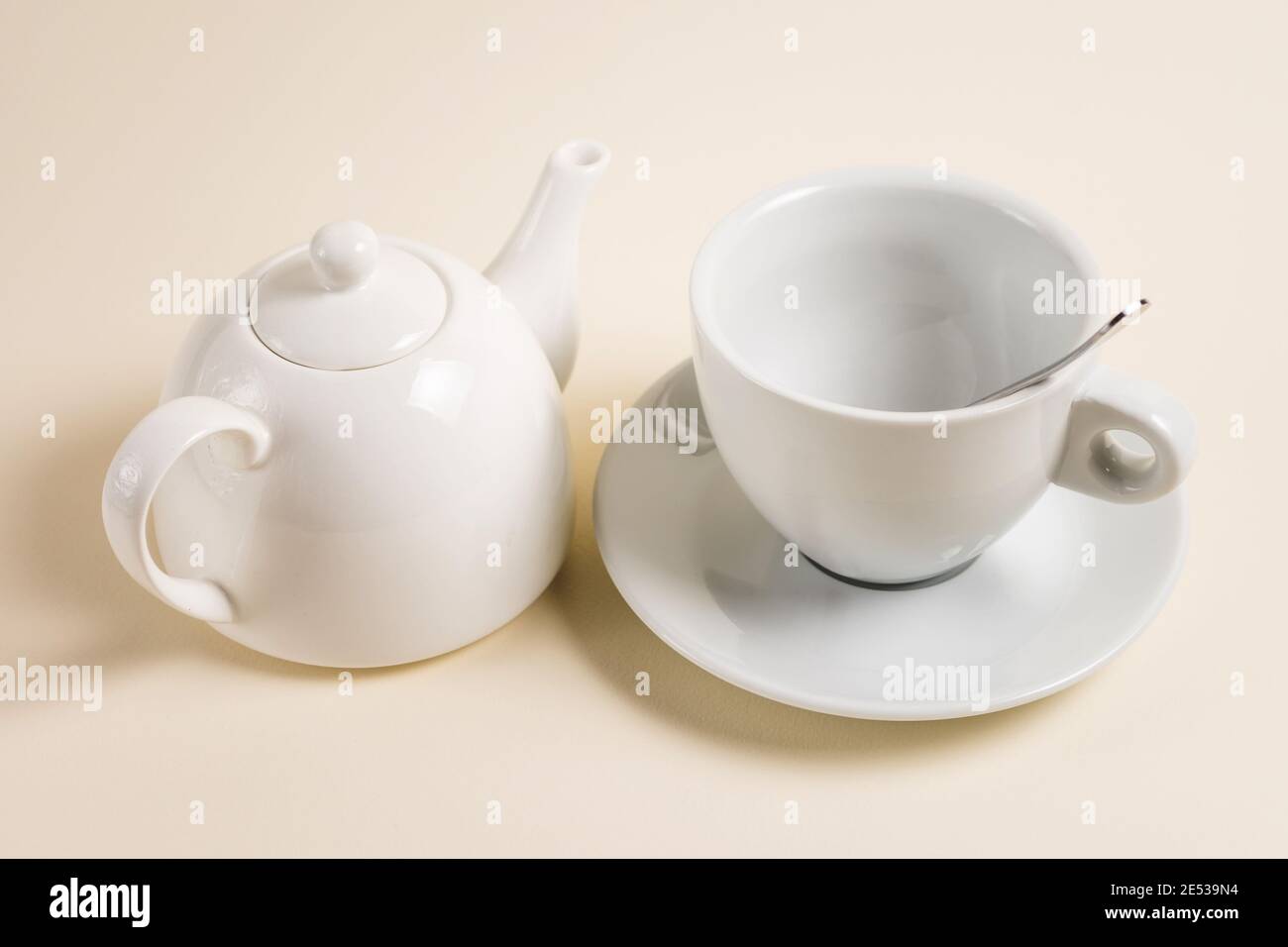 White teapot and an empty cup of tea spoon Stock Photo - Alamy