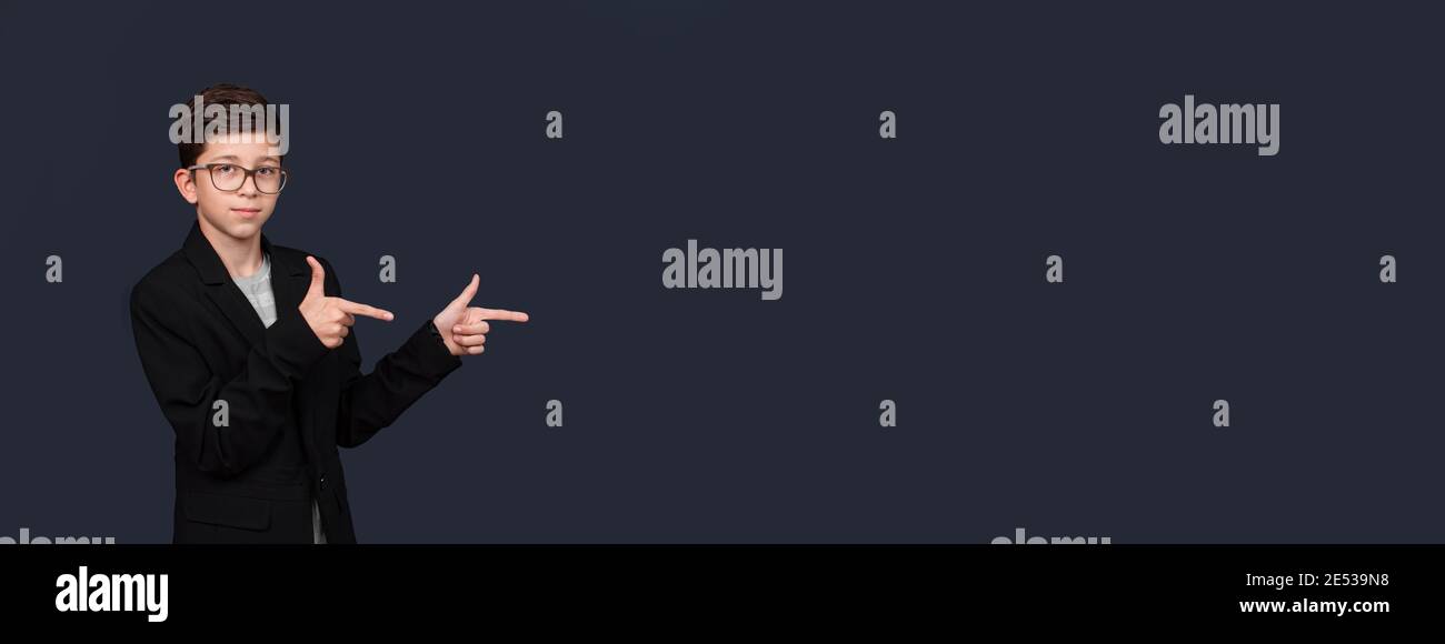 boy point his hands to empty place black background. banner Stock Photo ...