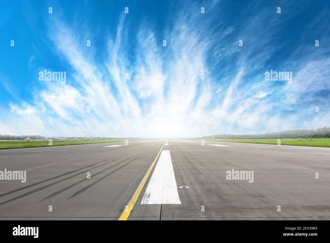 Empty runway strip with markings with beautiful clouds on the horizon ...