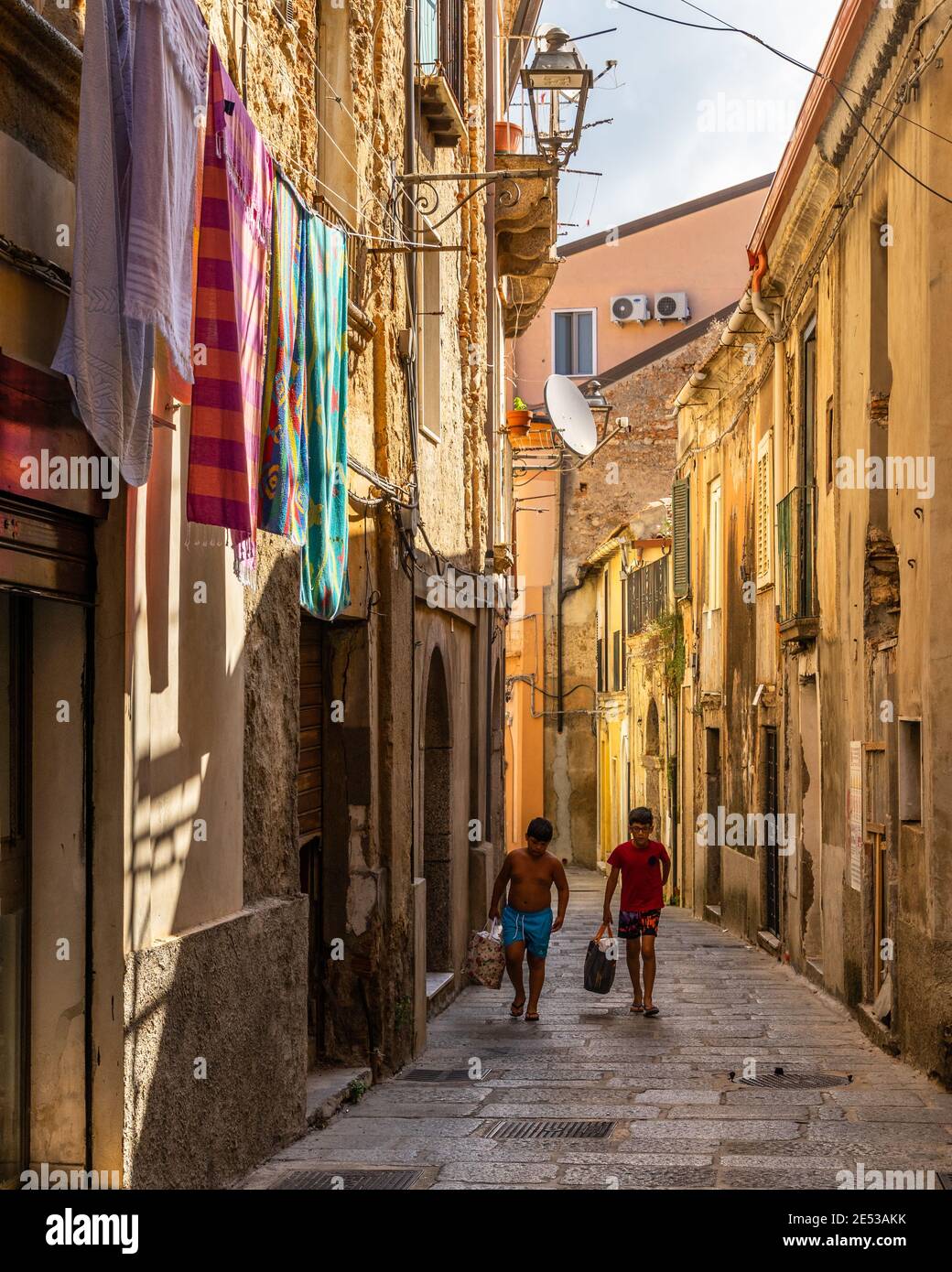 Nicotera, Calabria, Italy, Aug. 20 – Two boys walking in a typical ...