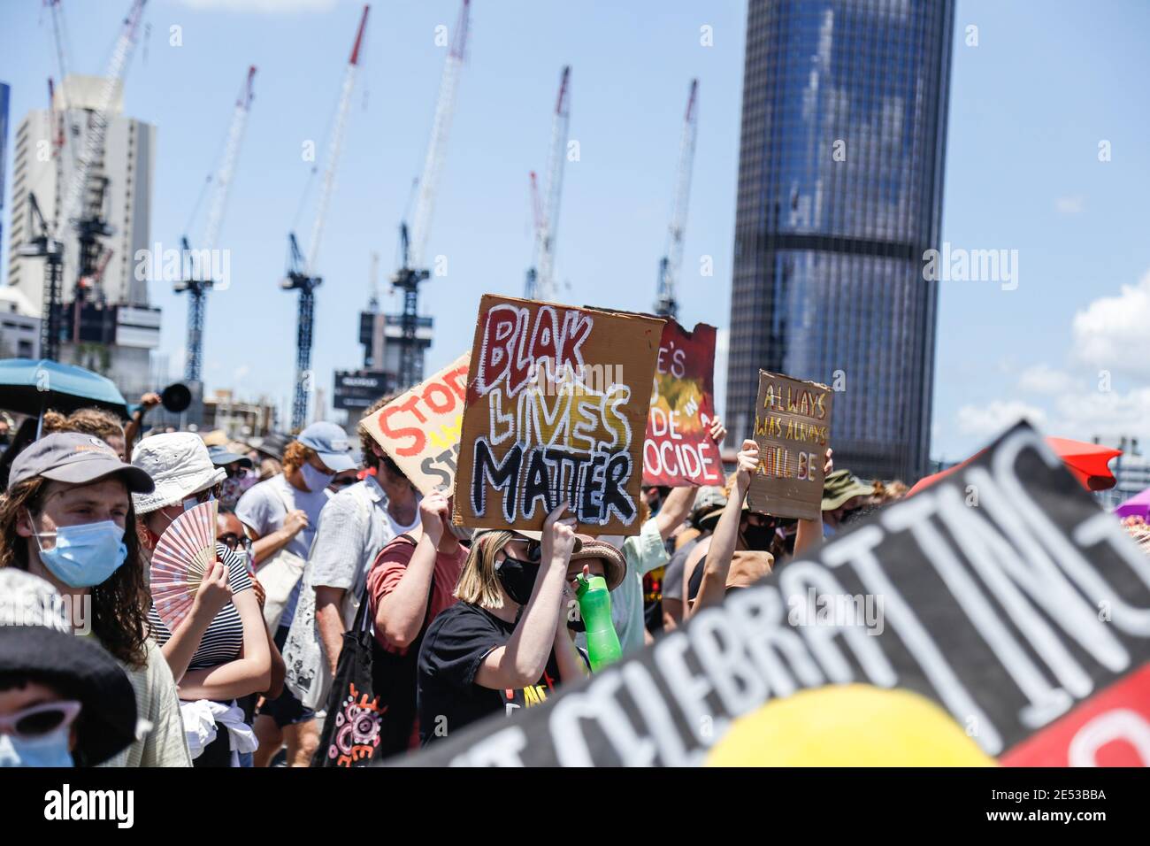 Protesters hold placards across Victoria Bridge during the march ...