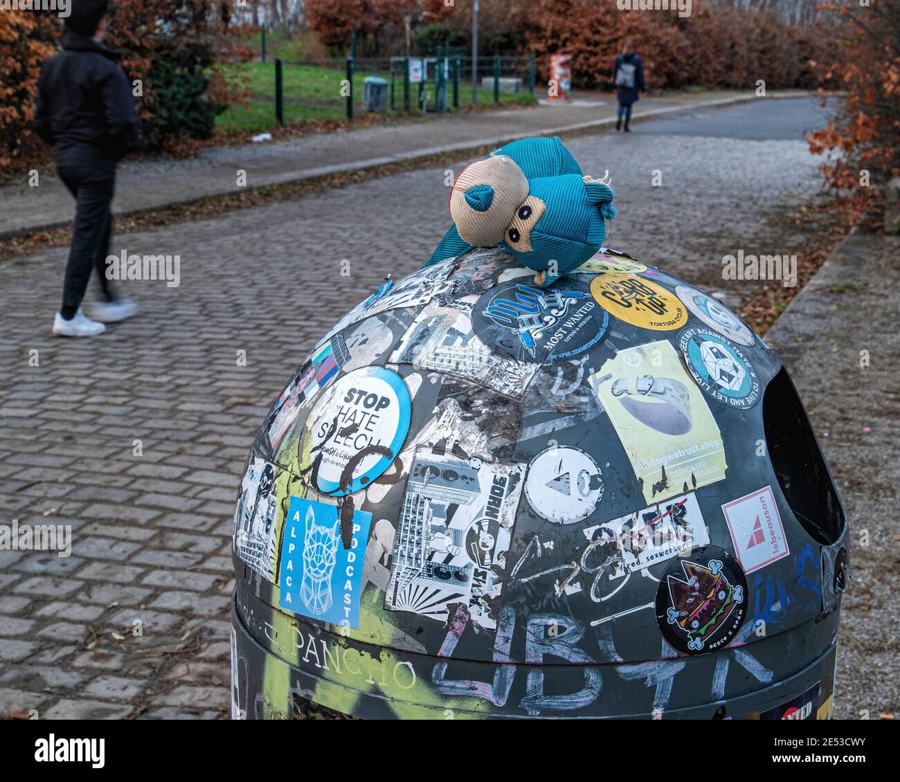 Abandoned soft toy on sticker covered trash can in Mauer Park, Berlin ...