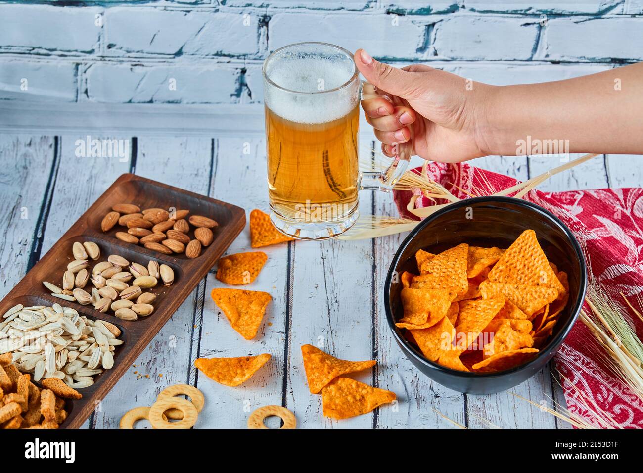 Assorted snacks, chips, and beer on blue table. Table for group of ...