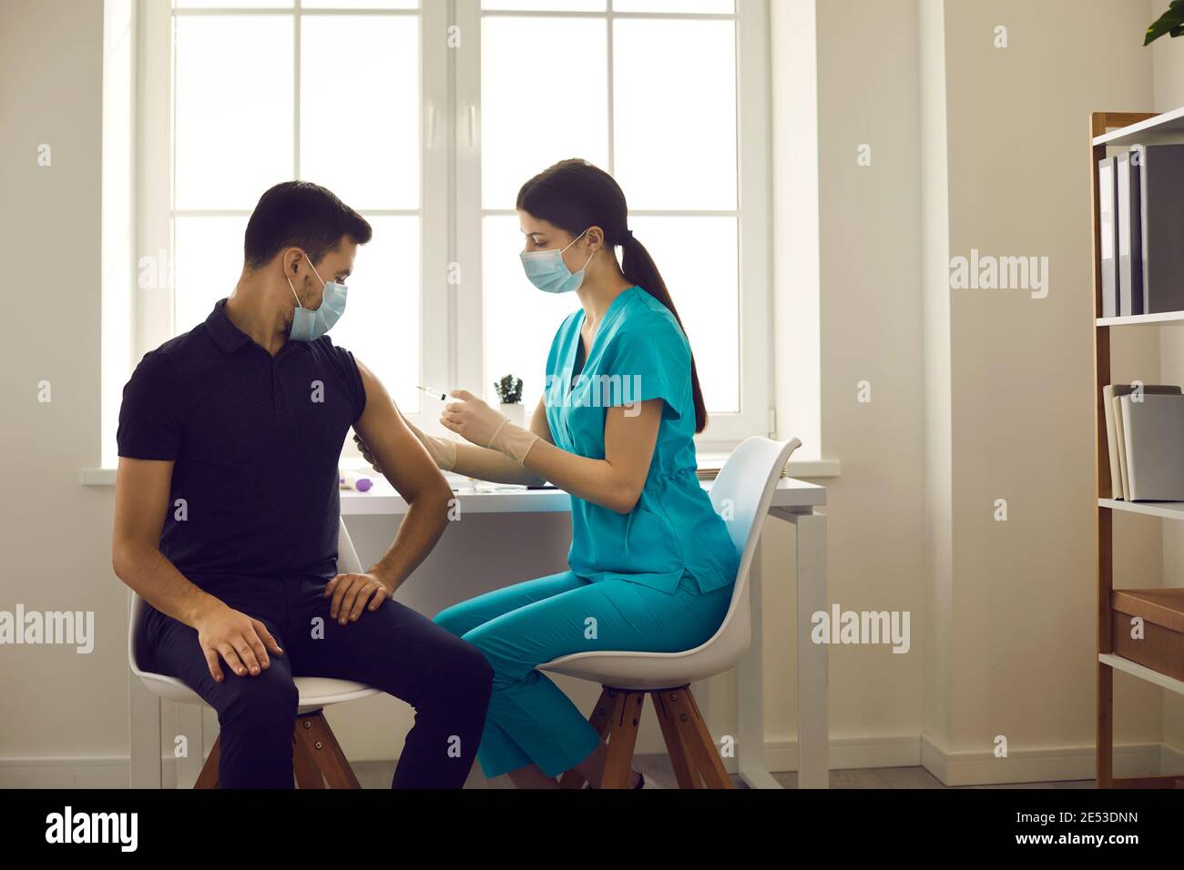 Nurse giving shot to patient hi-res stock photography and images - Alamy
