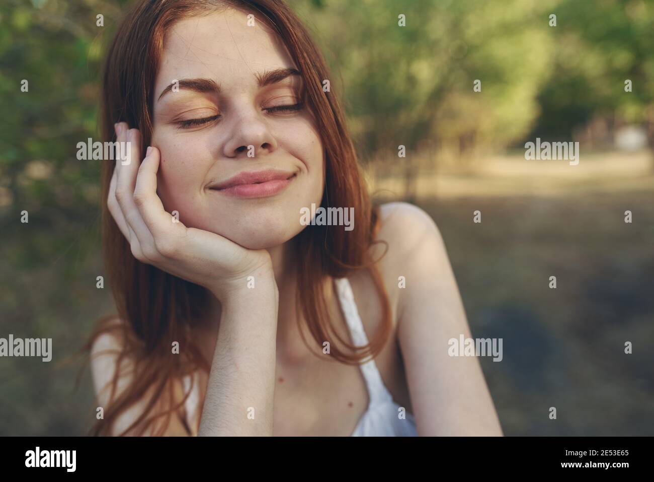 portrait of happy woman outdoors in garden and trees summer vacation ...