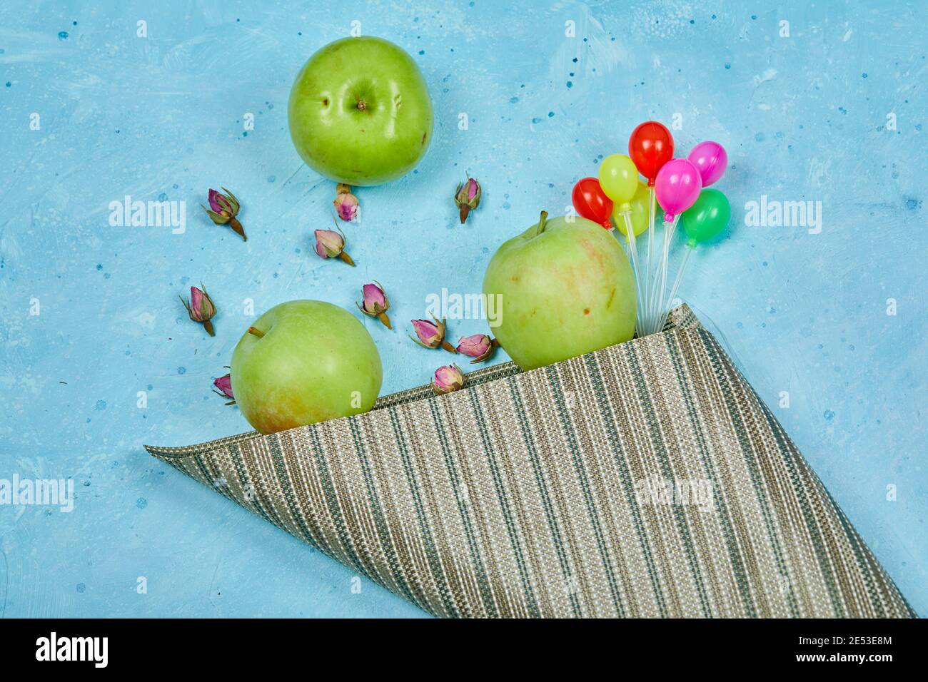 Green apple bouquet with flowers and balloons on blue background Stock ...