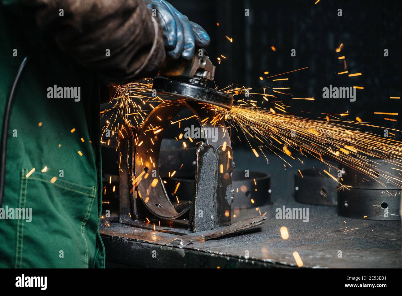 angle grinder at work, yellow tracks from sparks flying away in the ...