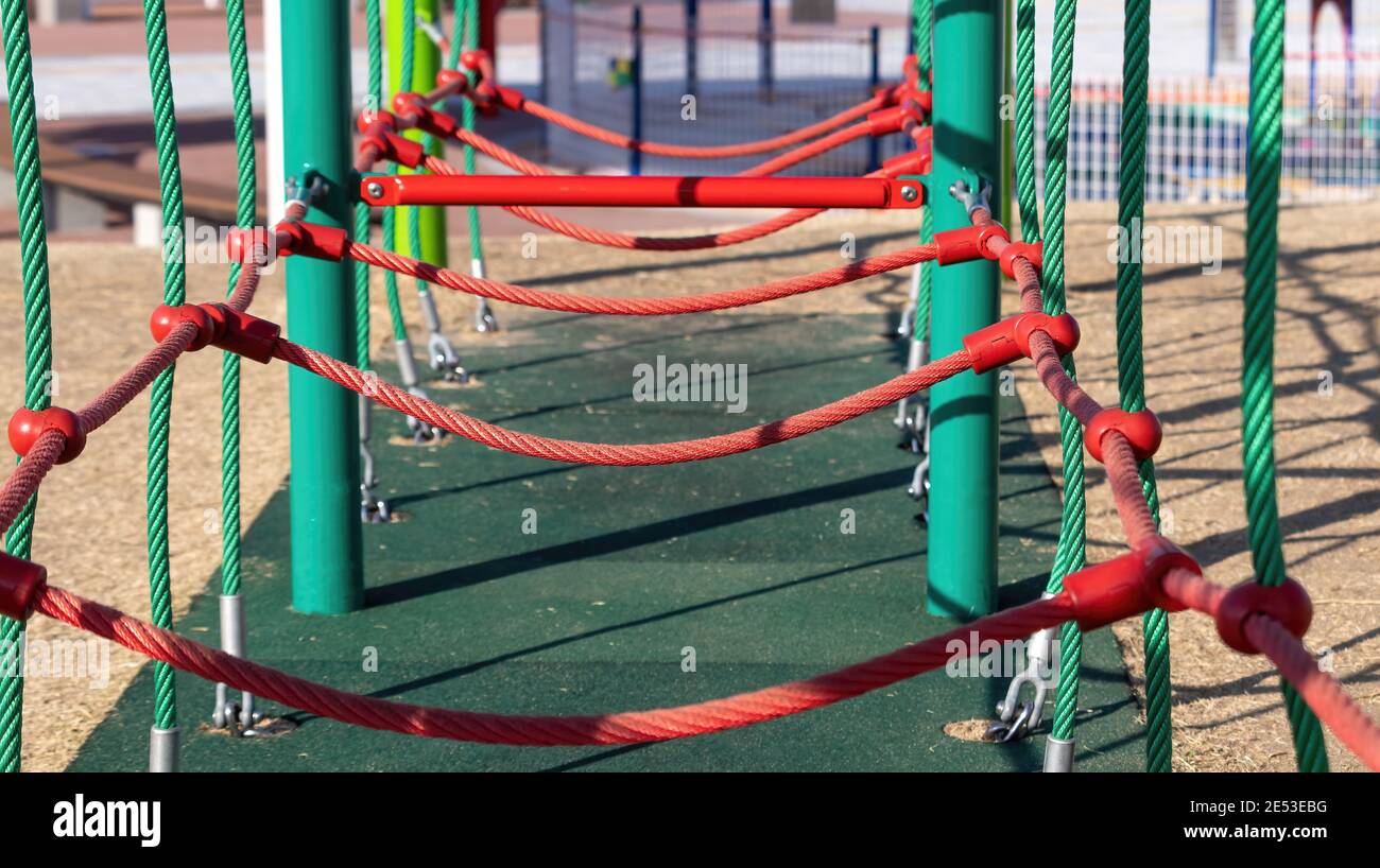 Orange ropes and green metal pipes, create an obstacle course for kids ...