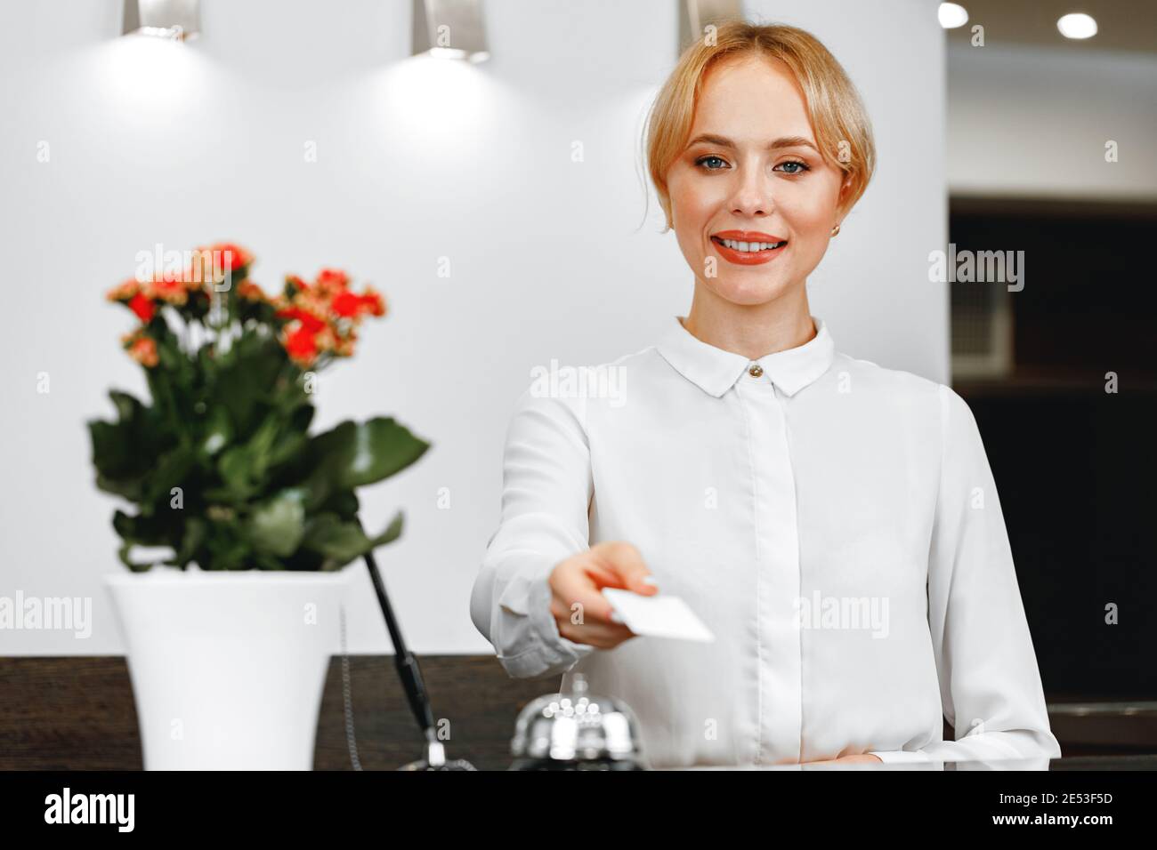 Portrait of beautiful blonde woman hotel receptionist Stock Photo - Alamy