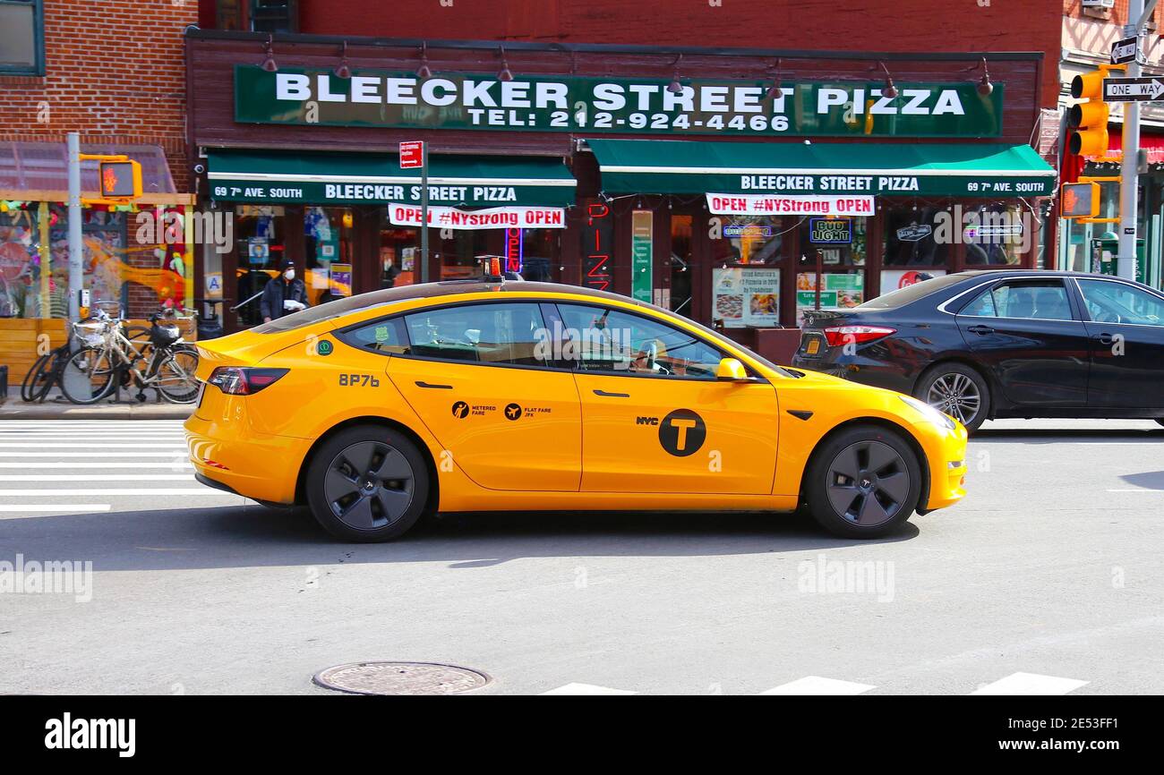 Tesla Model 3 yellow cab on the street in Downtown, New York City, NY ...