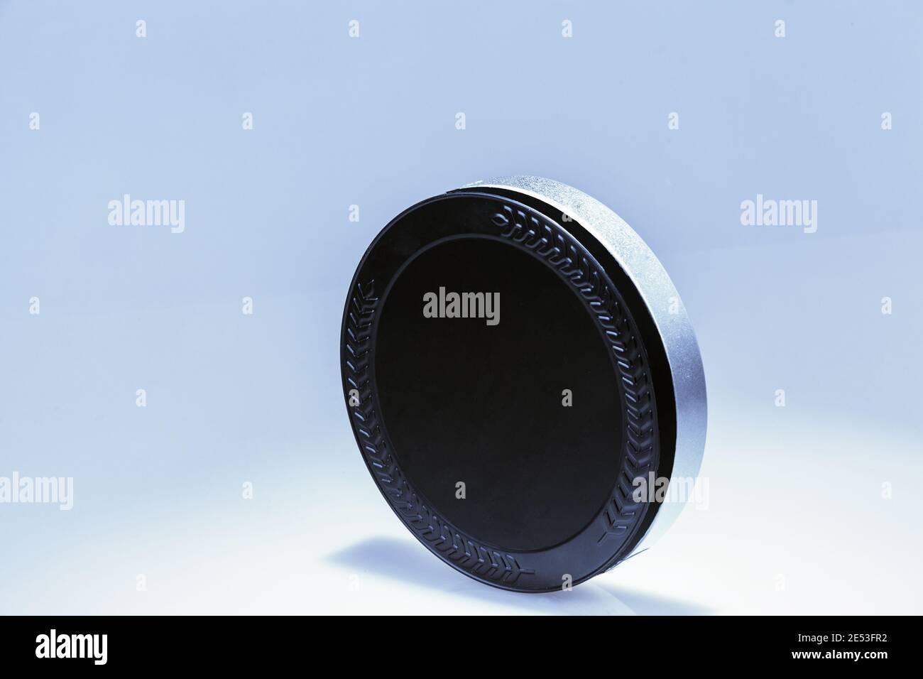 Flat metal box with black lid and silver base standing on end Stock ...