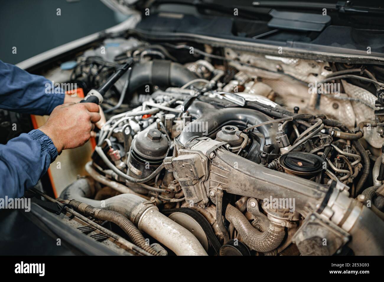 Man checks car engine under hi-res stock photography and images - Alamy