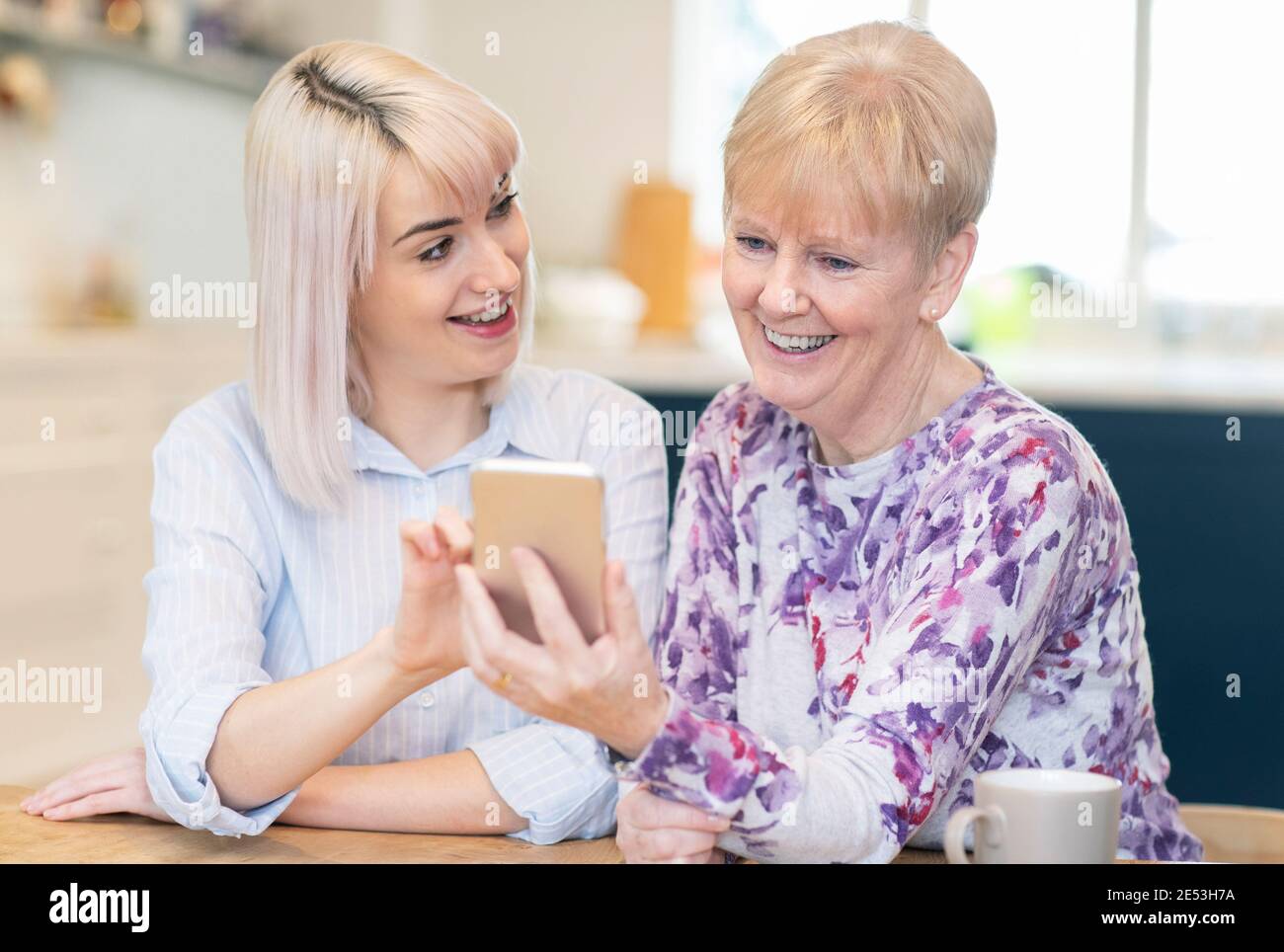 oman Helping Senior Neighbor Expaining How To Use Mobile Phone Stock ...