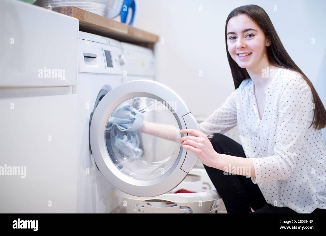 Portrait Of Teenage Girl Helping With Domestic Chores At Home Emptying ...