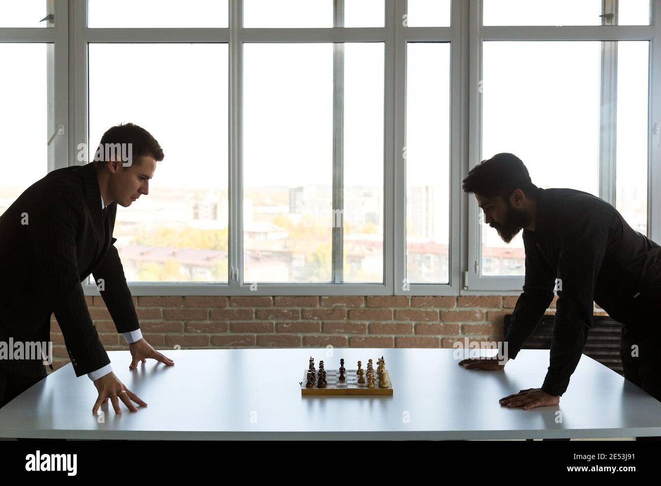 two male businessmen, rivals are playing chess. Strategy and rivalry ...