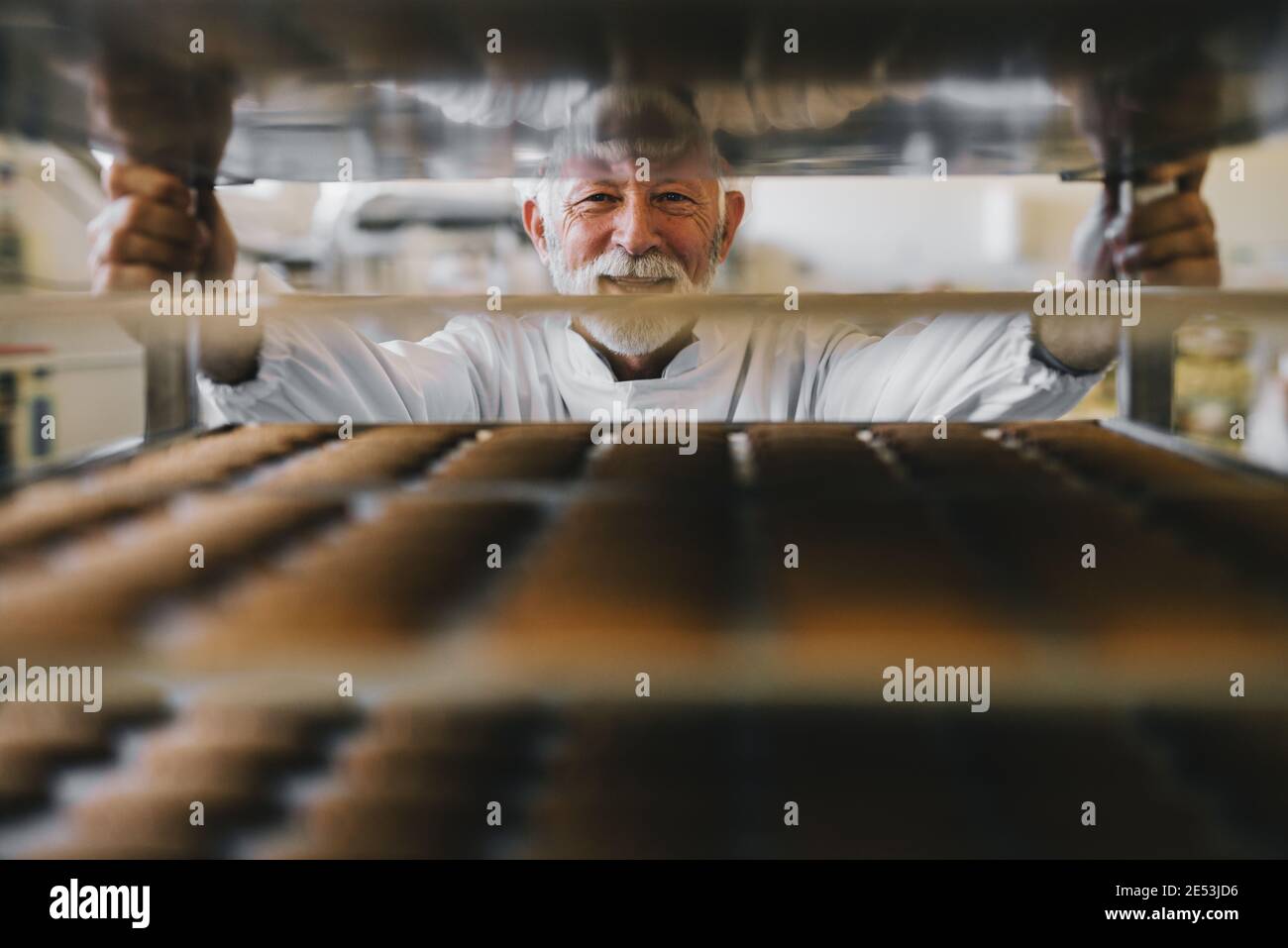 Picture of professional mature male baker man in white work uniform ...
