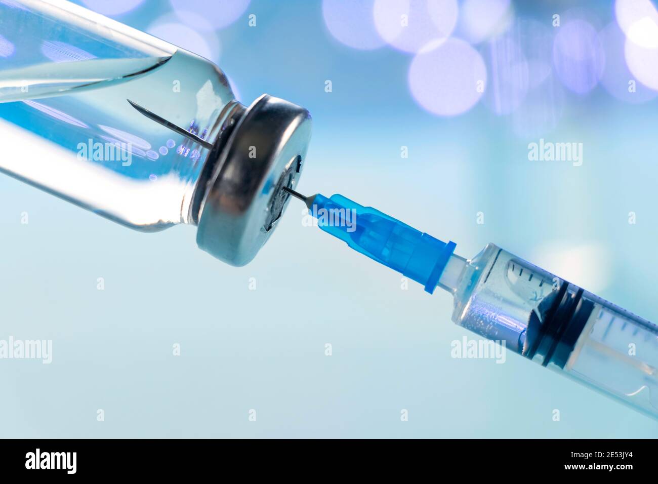 Vaccine vial dose flu shot drug needle syringe on blue background ...