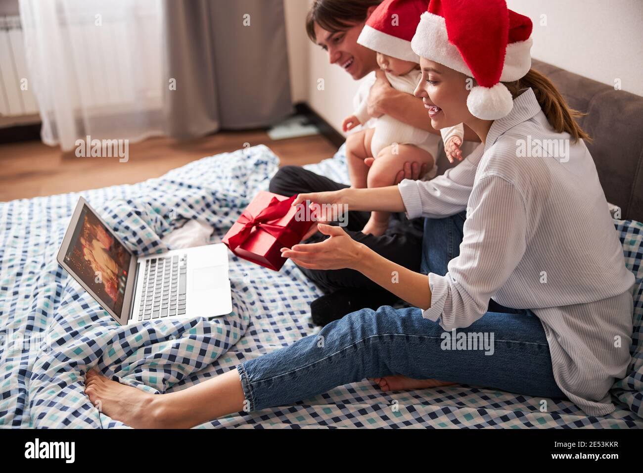 Attractive young woman showing present on camera Stock Photo - Alamy