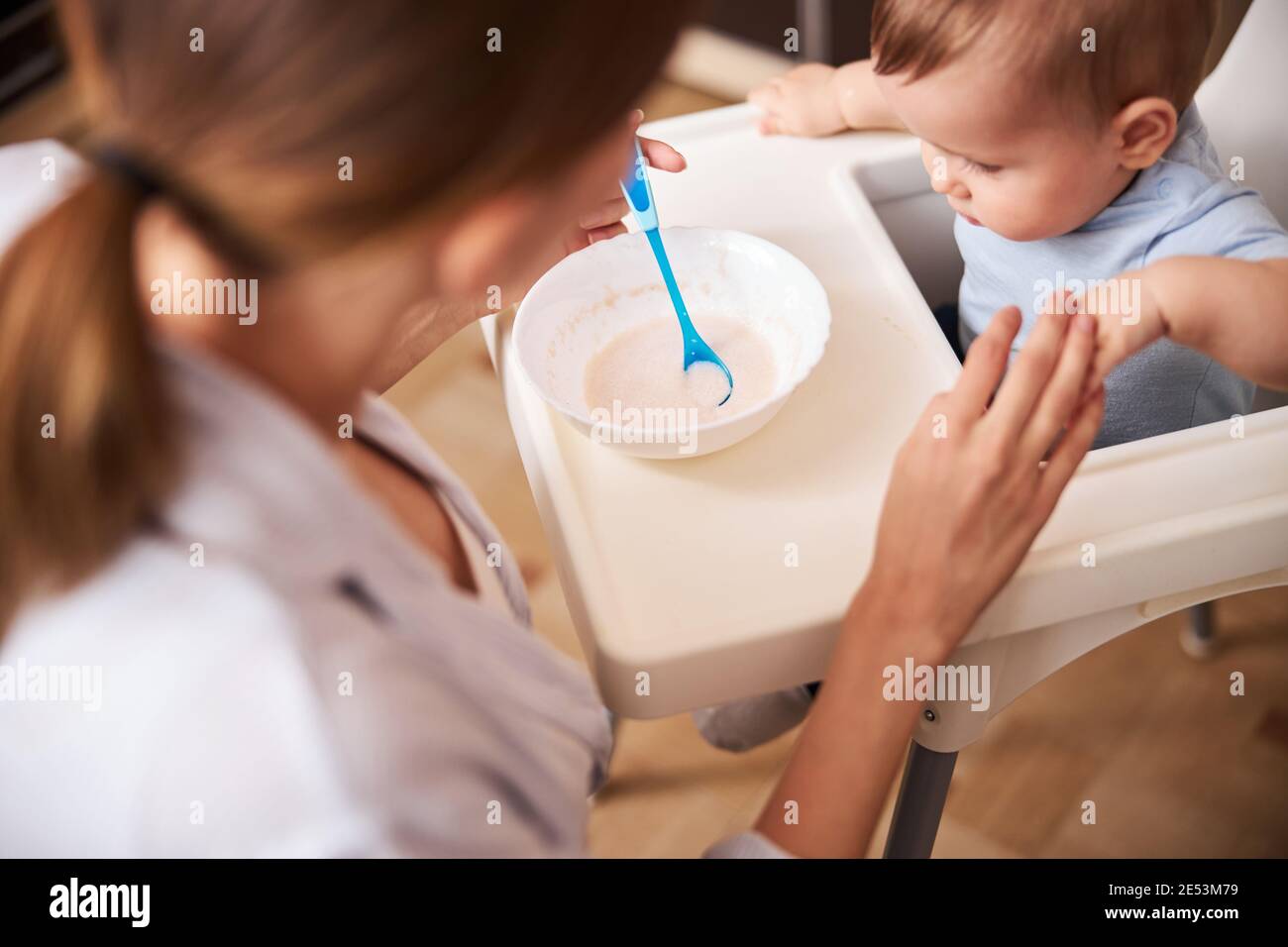 Careful young parent taking care of her child Stock Photo - Alamy