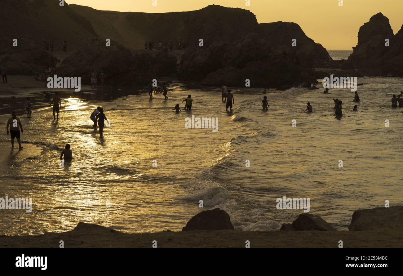 SAN JUAN DE MARCONA, PERU - Jan 15, 2015: silhouettes of many bathers ...