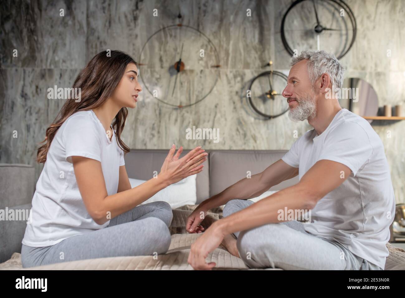 Woman and man talking sitting opposite each other Stock Photo - Alamy