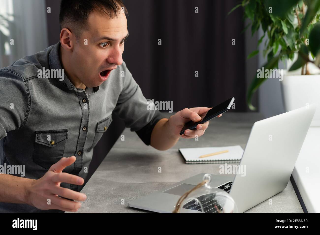 Mad stressed young man angry about stuck laptop or pc failure, furious ...