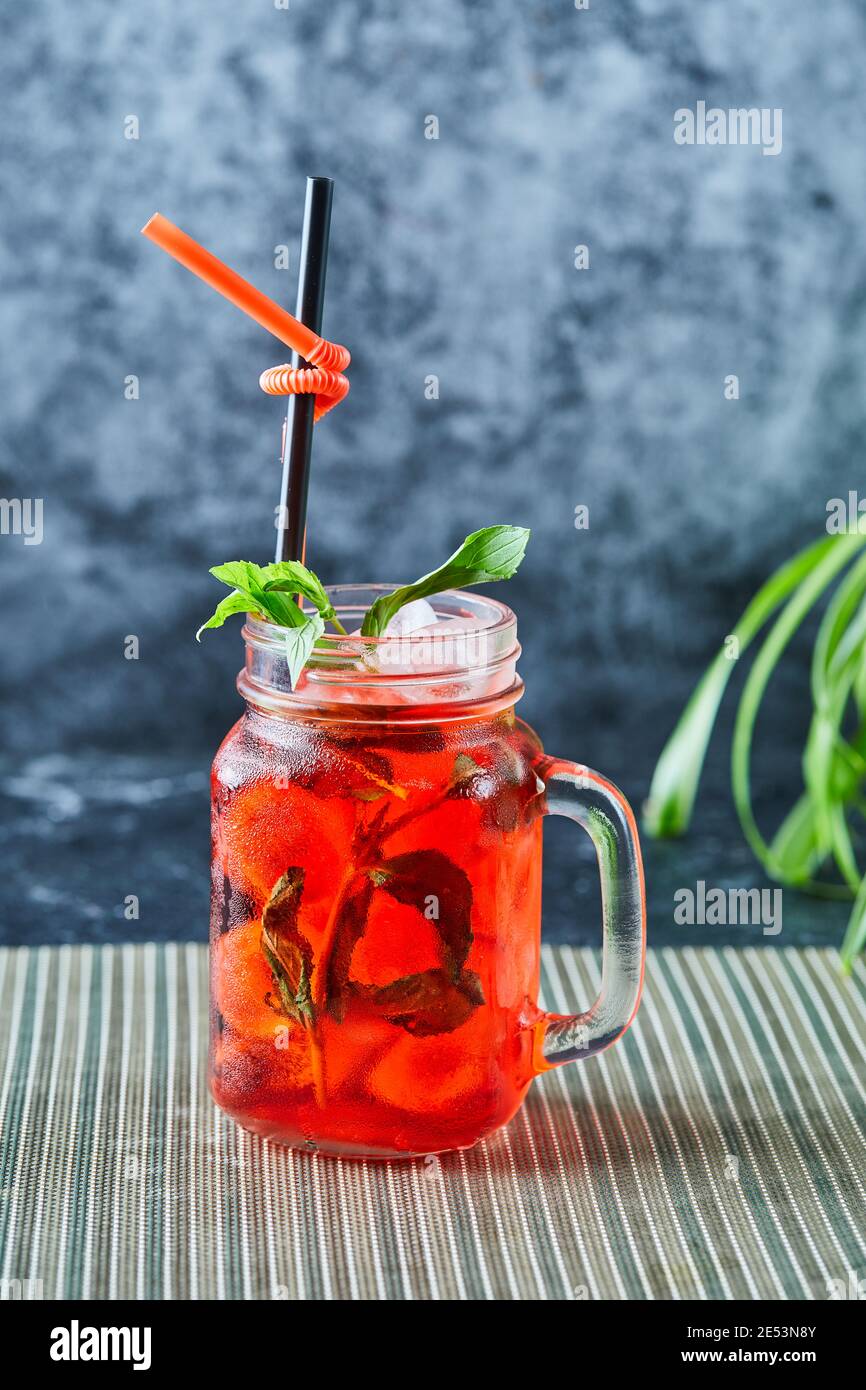 Strawberry lemonade with ice, straw mint in the dark background Stock ...