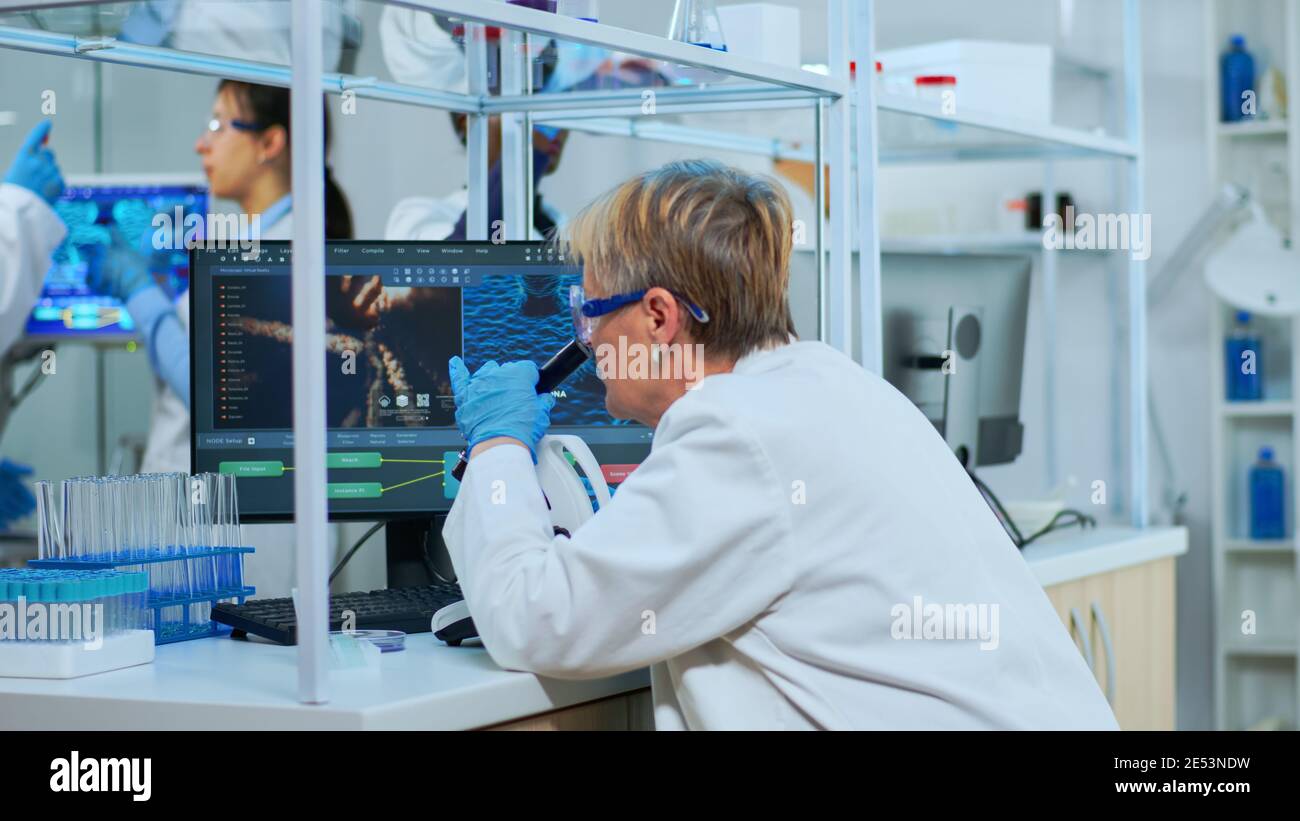 Black woman looking through microscope hi-res stock photography and ...