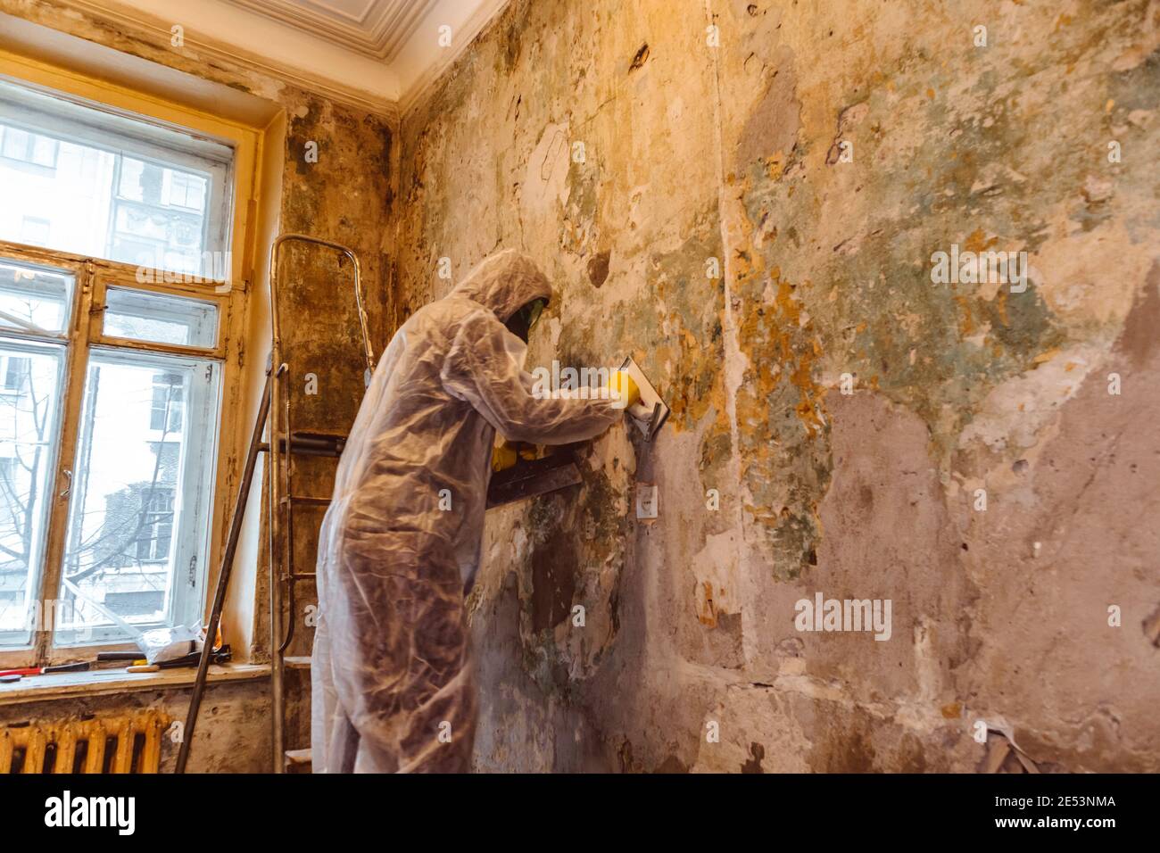 working plasterer works putting wall finishing work wall indoors stucco ...