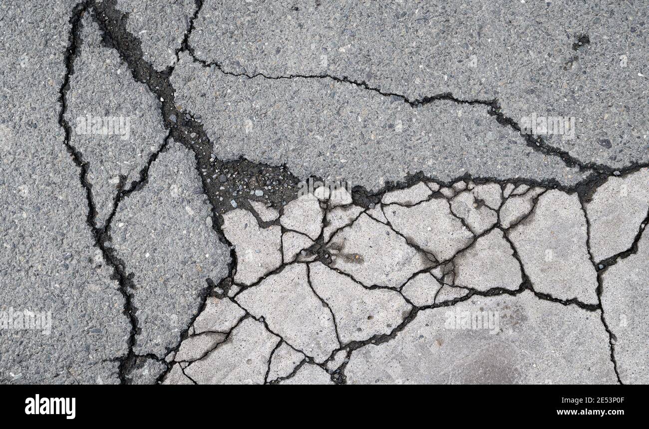 Asphalt road with small rocks and cracks Stock Photo - Alamy