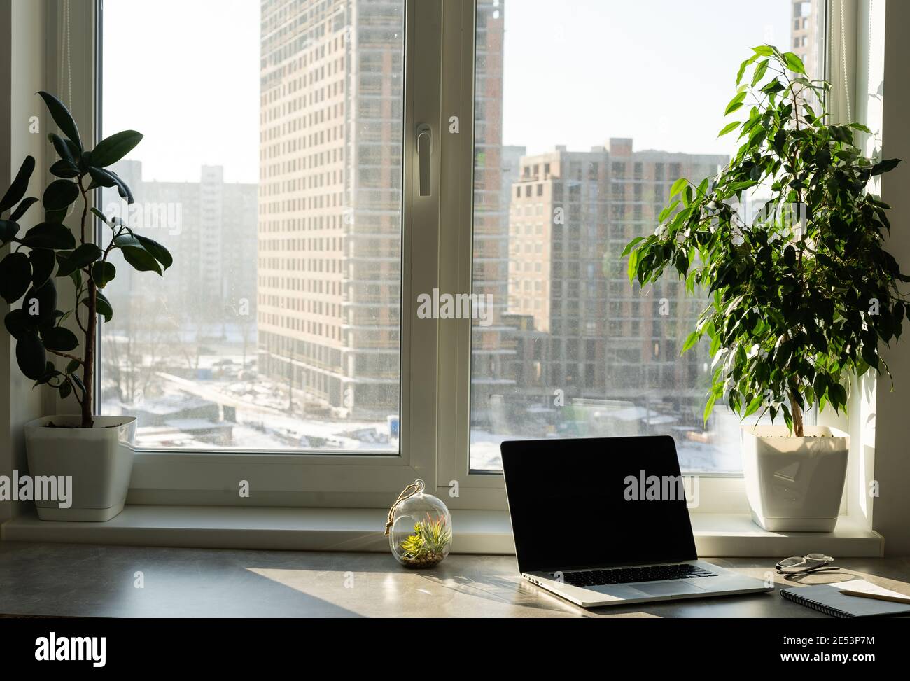 Still life view of office room with open laptop computer on desk with ...