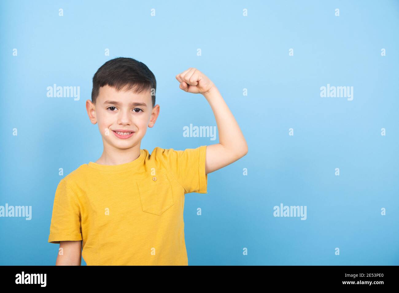 Portrait of cute kid boy showing the muscle of his arm. Power boy Stock ...