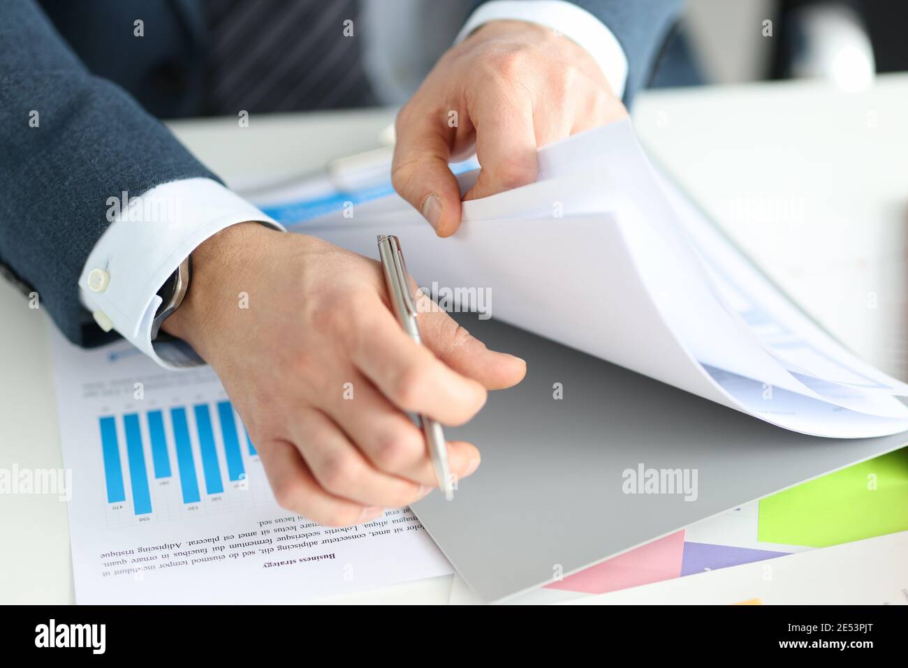 Man in business suit examining documents at workplace closeup Stock ...