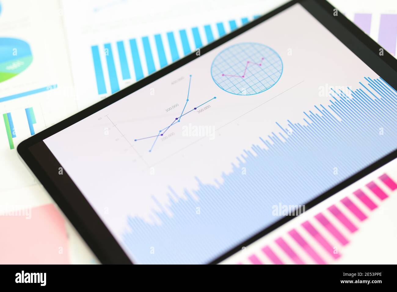 Digital tablet with graphs and charts lying on documents closeup Stock ...