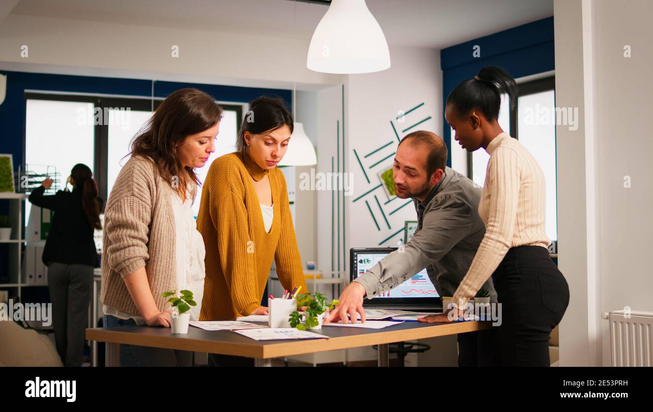 Diverse business people communicating in start up business office ...